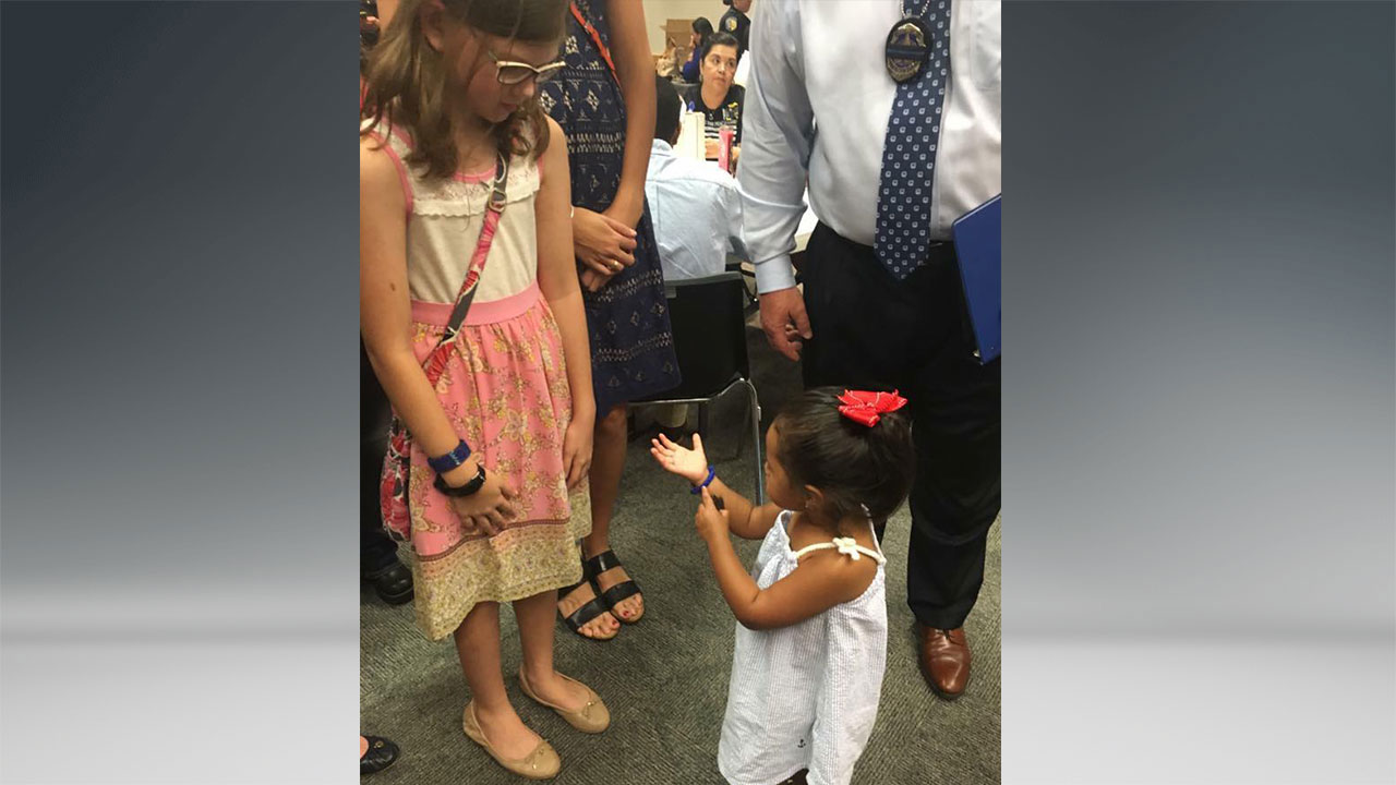Touching moment between daughters of fallen officers | wfaa.com